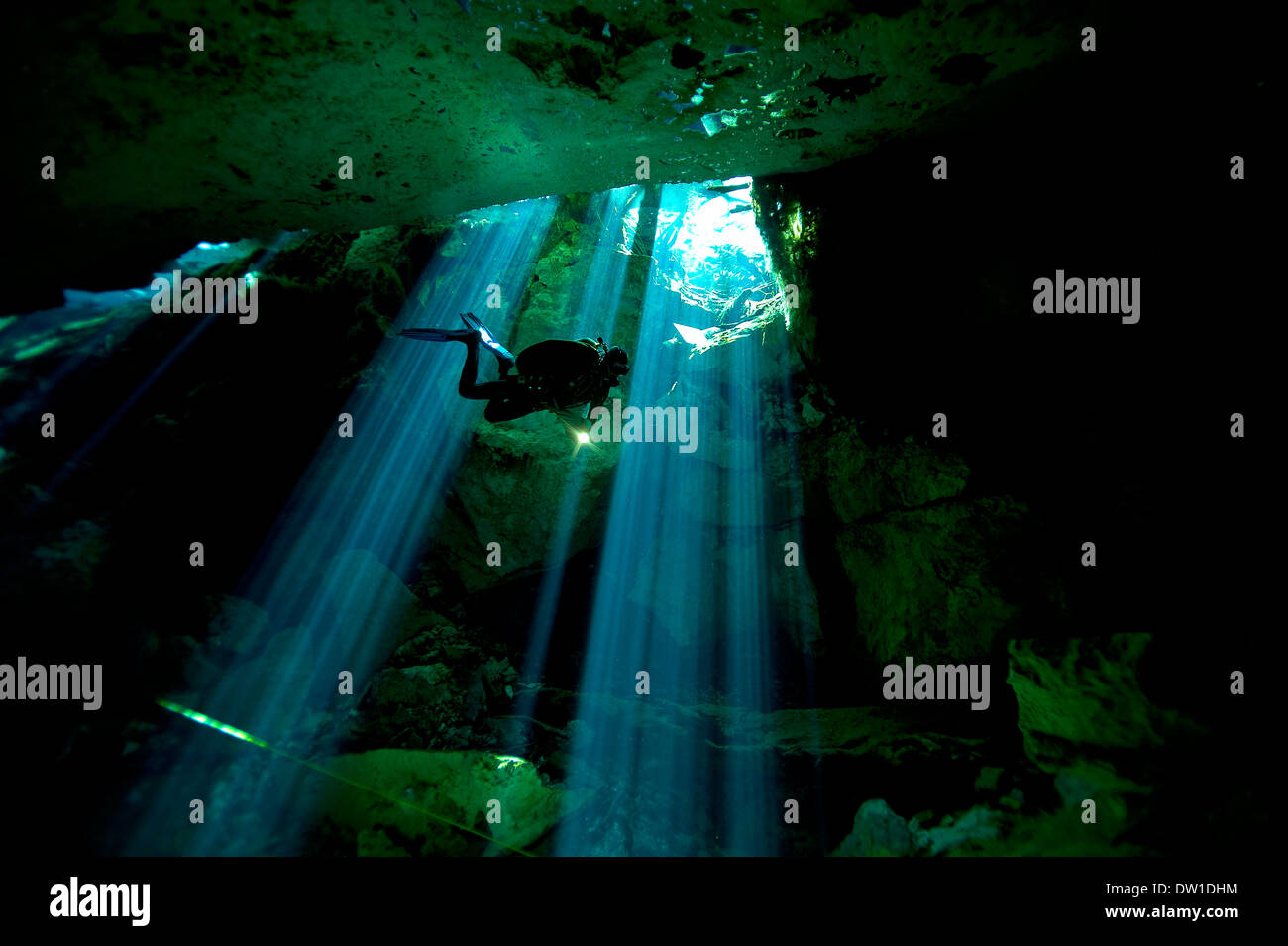 Scuba diver swimming thru the underwater Kulukan Cenote cave, Yucatan ...