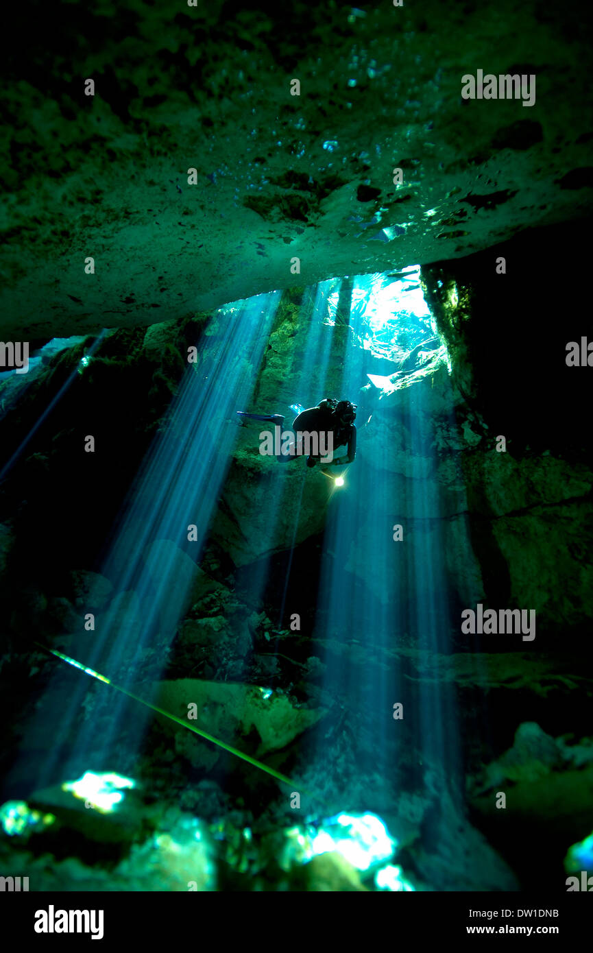 Scuba diver swimming thru the underwater Kulukan Cenote cave, Yucatan ...