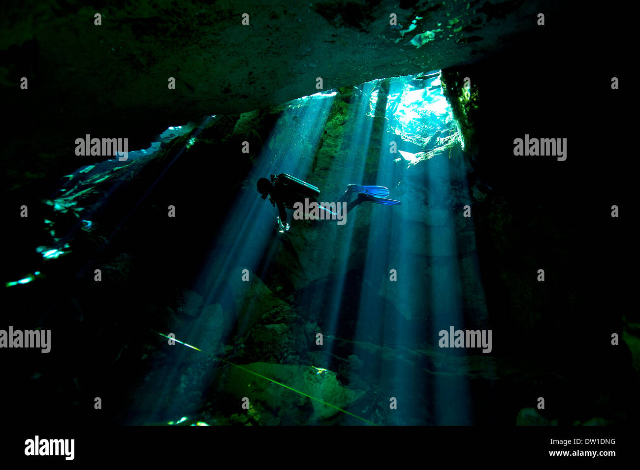 Scuba diver swimming thru the underwater Kukukan Cenote cave, Yucatan ...
