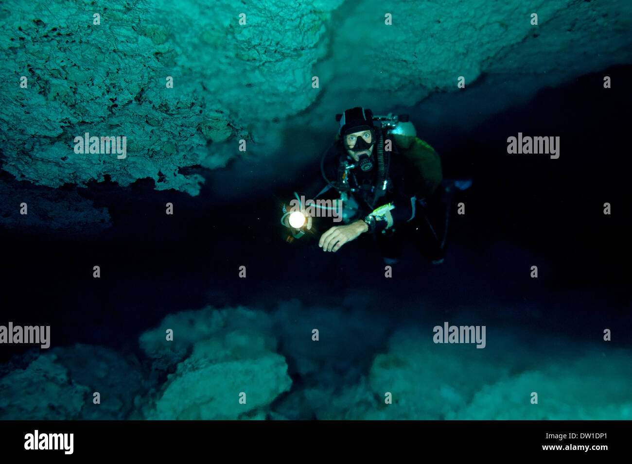 Scuba diver swimming thru the underwater Kulukan Cenote cave, Yucatan ...