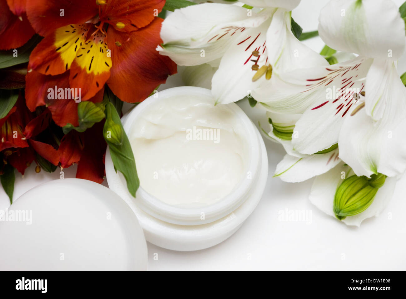 cosmetic moisturizing cream with flowers Stock Photo - Alamy