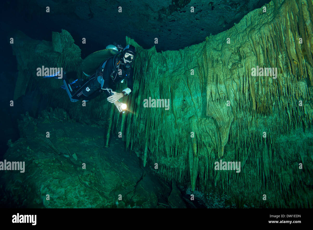 Scuba diver swimming thru the underwater Chac Mool Cenote cave, Yucatan ...
