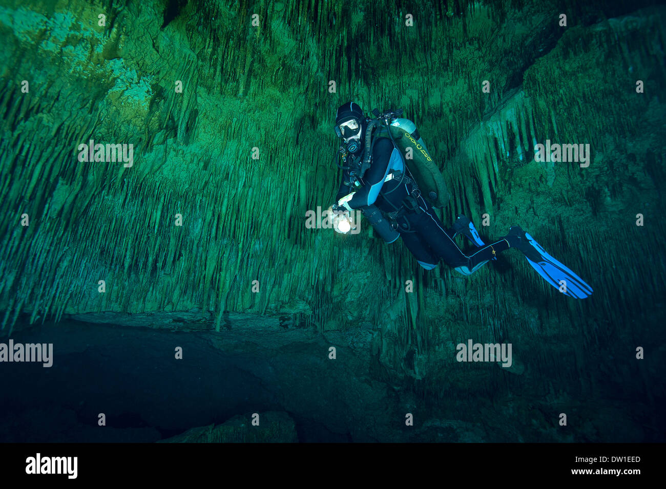 Scuba diver swimming thru the underwater Chac Mool Cenote cave, Yucatan ...