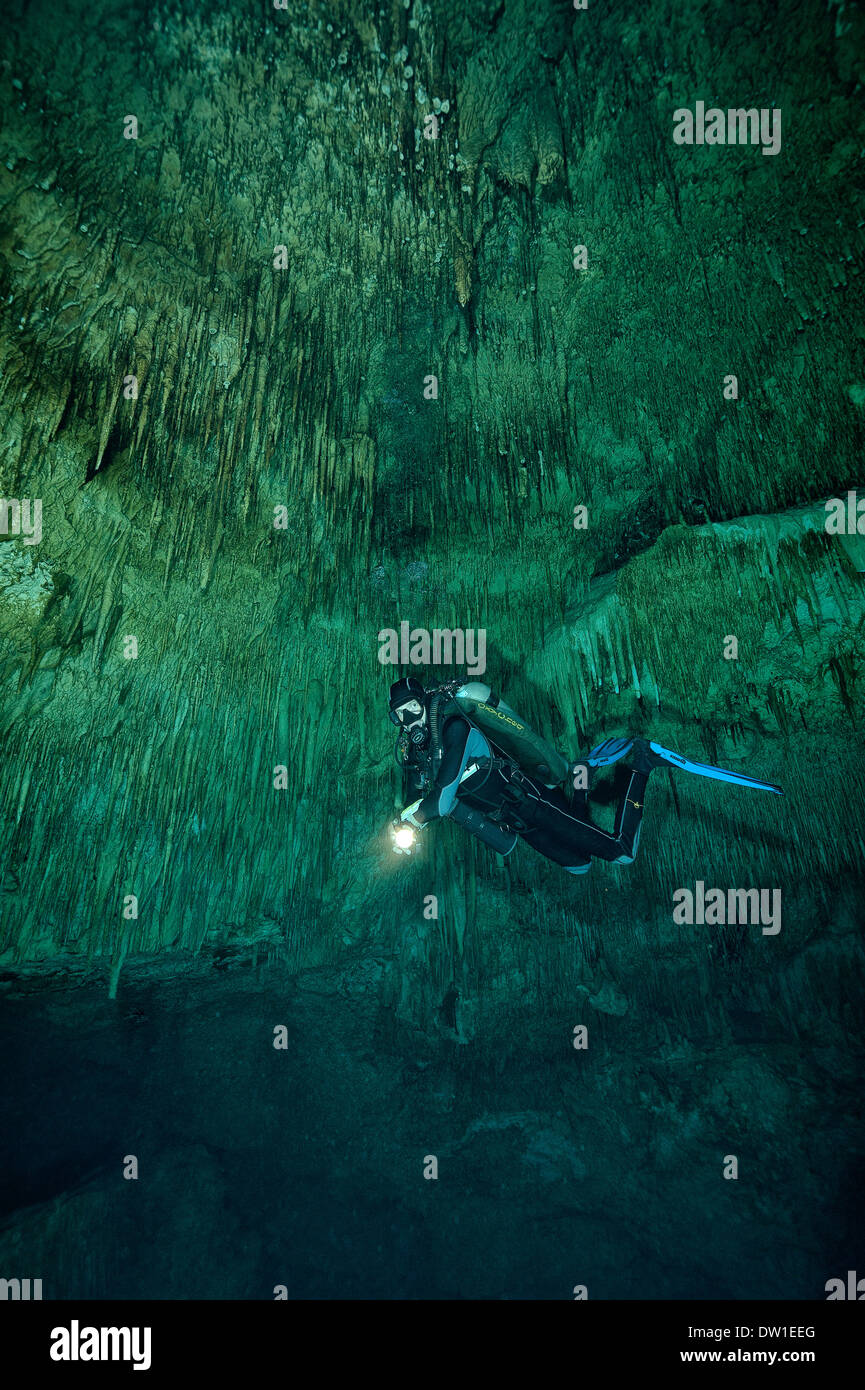 Scuba diver swimming thru the underwater Chac Mool Cenote cave, Yucatan ...