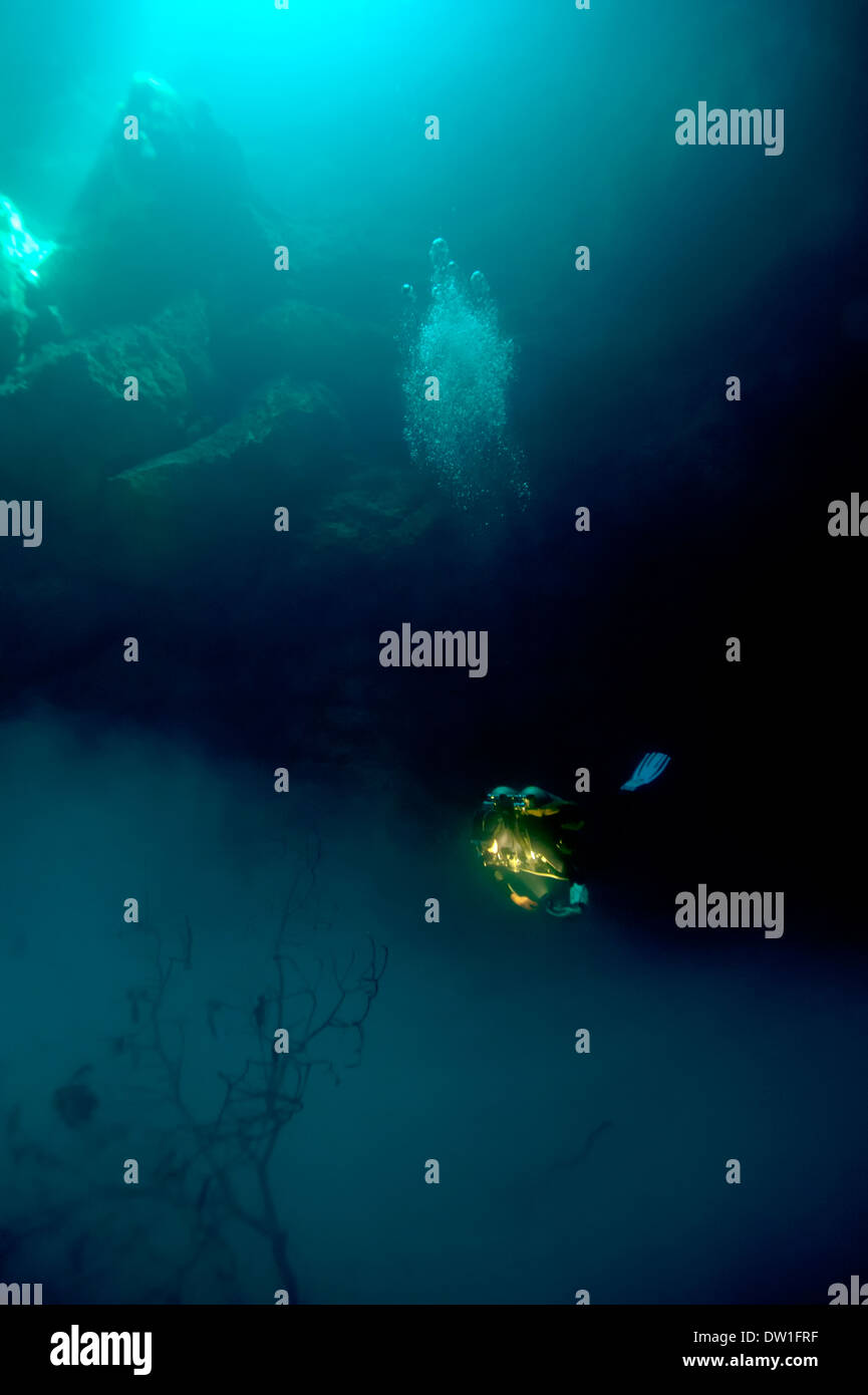 Scuba diver swimming thru the underwater cenote Pit cave, Yucatan ...