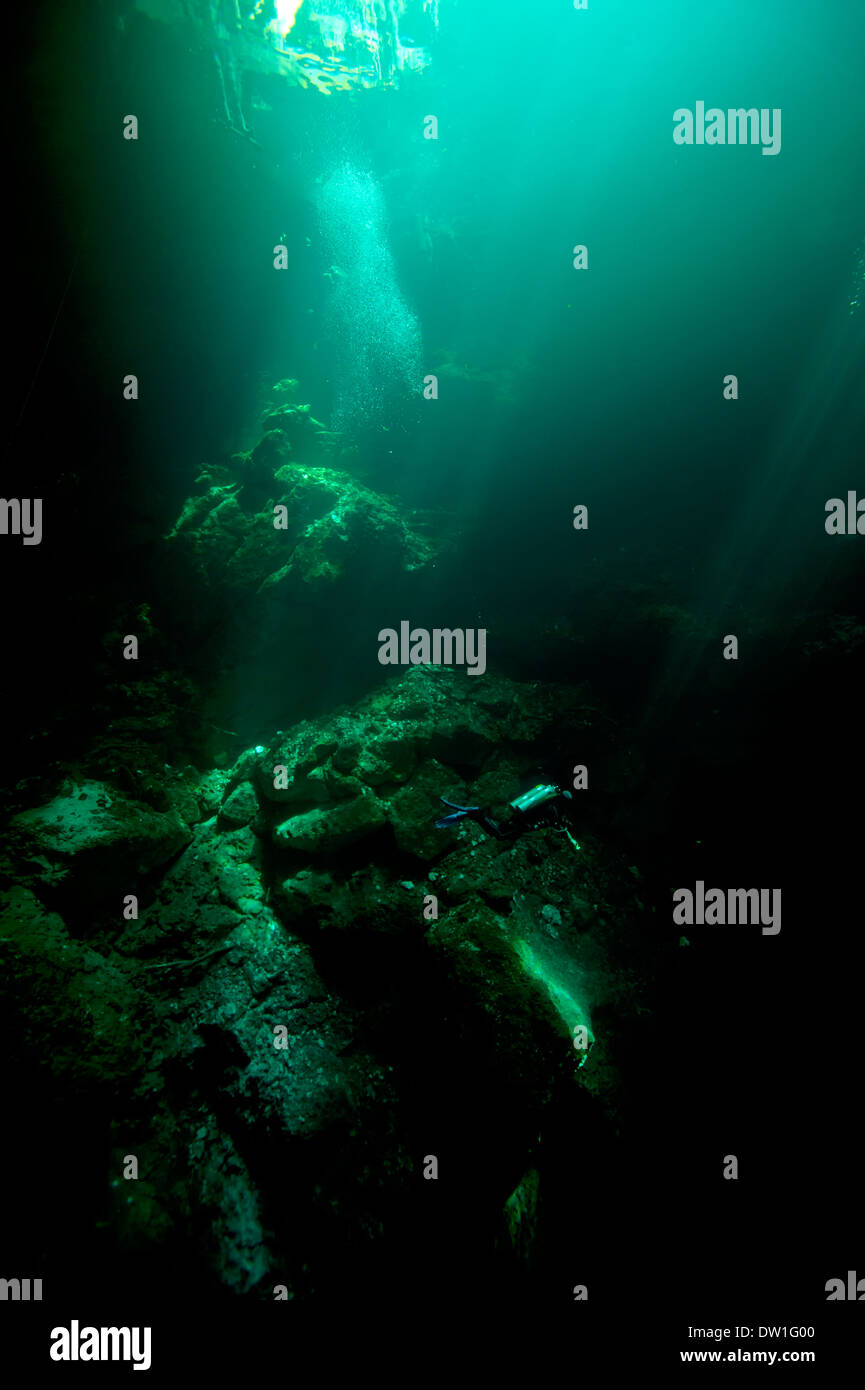 Scuba diver swimming thru the underwater cenote Pit cave, Yucatan ...