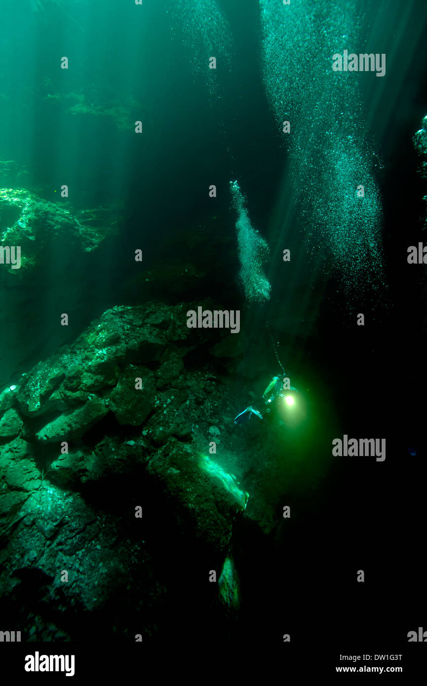 Scuba diver swimming thru the underwater cenote Pit cave, Yucatan ...