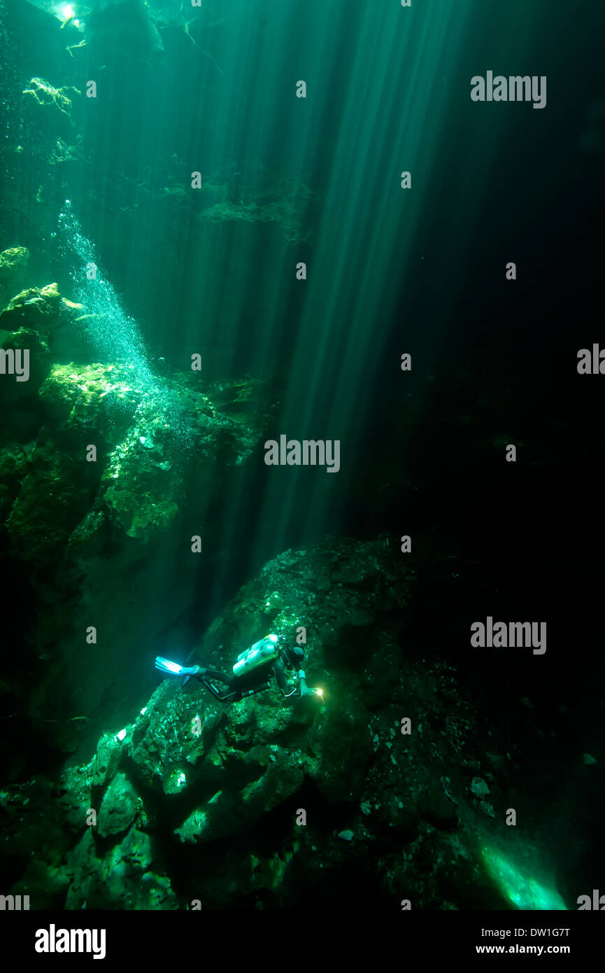 Scuba diver swimming thru the underwater cenote Pit cave, Yucatan ...