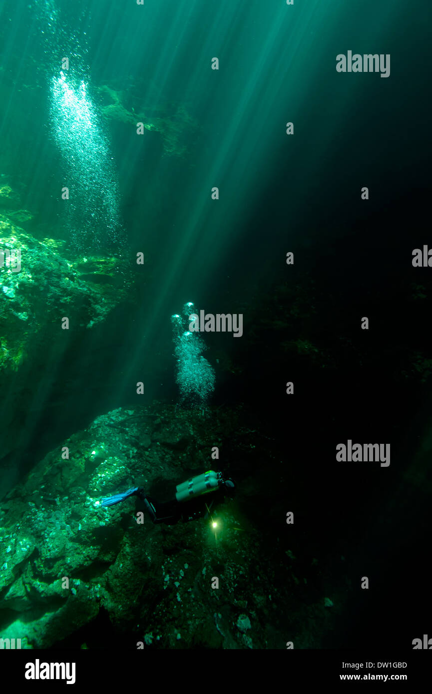 Scuba diver swimming thru the underwater cenote Pit cave, Yucatan ...