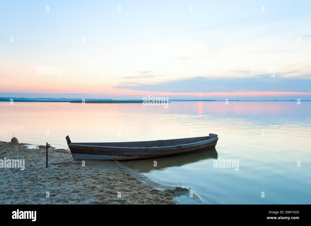 Sunset with boat near the summer lake shore Stock Photo - Alamy