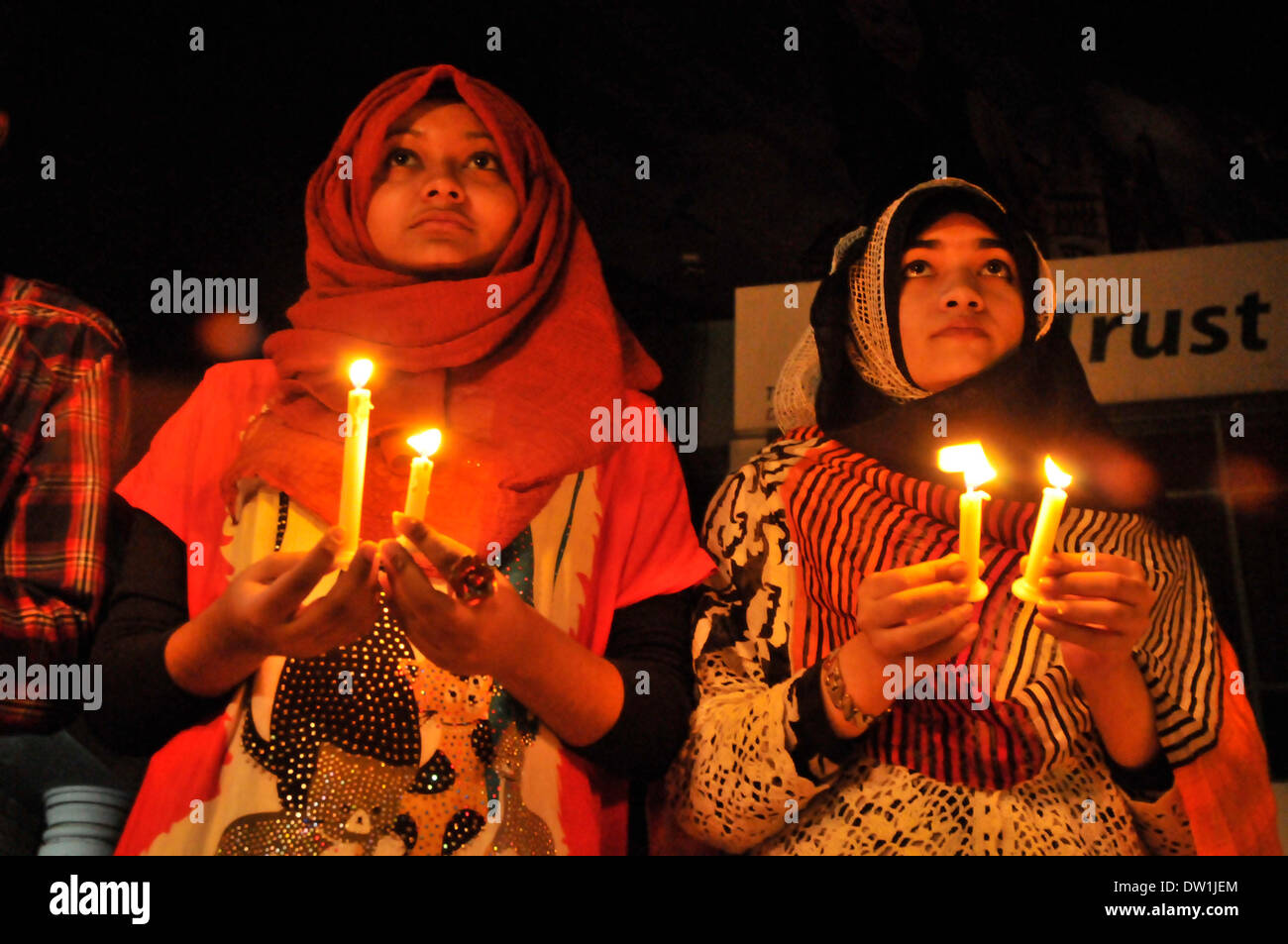 Dhaka, Bangladesh. 25th Feb, 2014. People hold candles in front of the ...