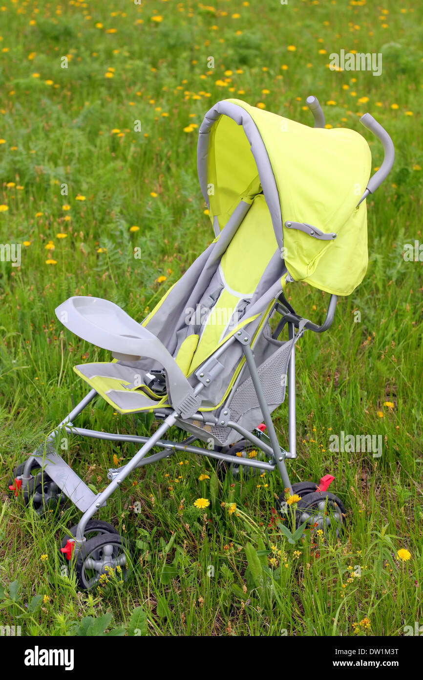 baby stroller on green lawn Stock Photo - Alamy