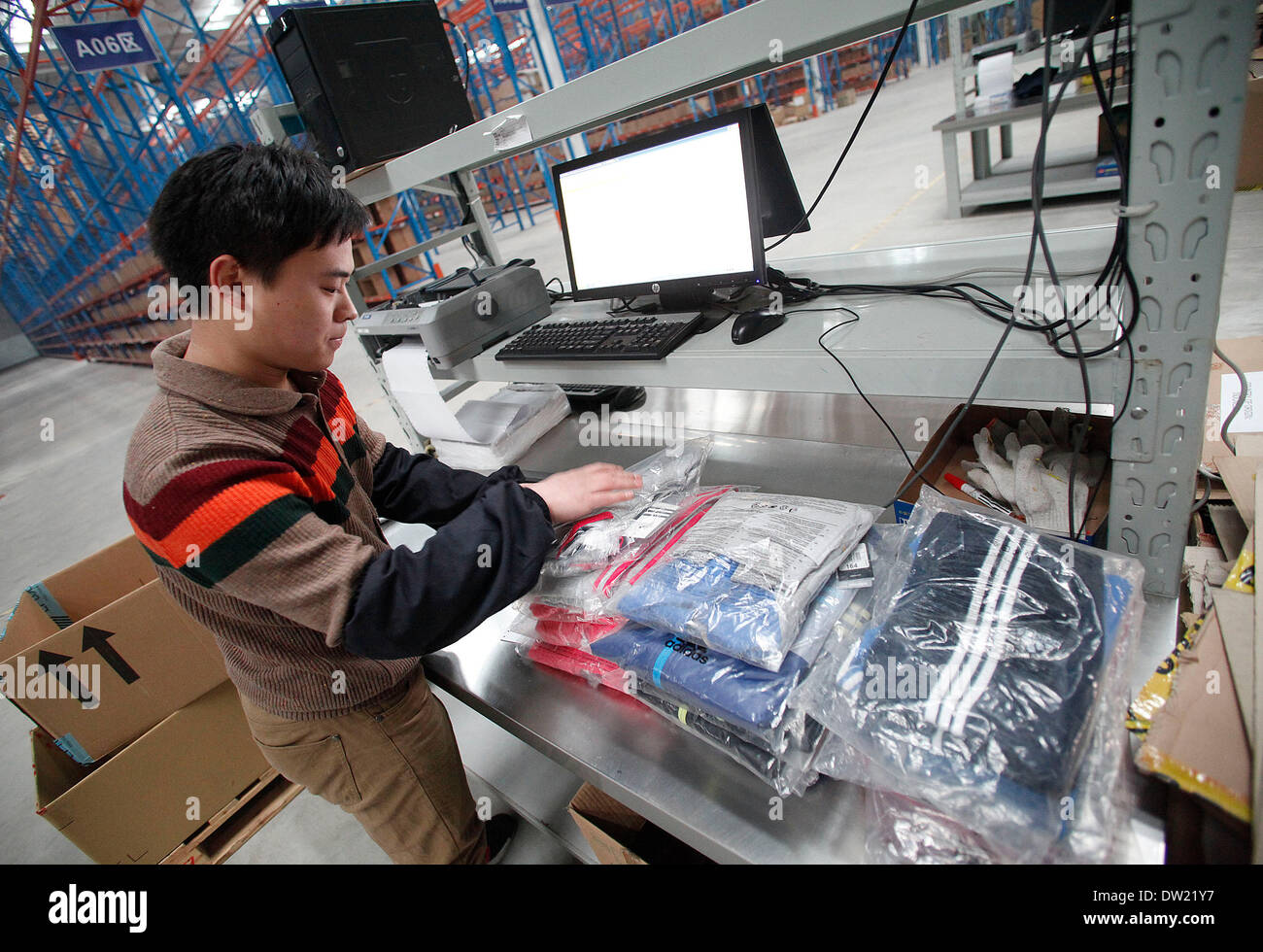 Langfang, China's Hebei Province. 25th Feb, 2014. A worker scans goods ...