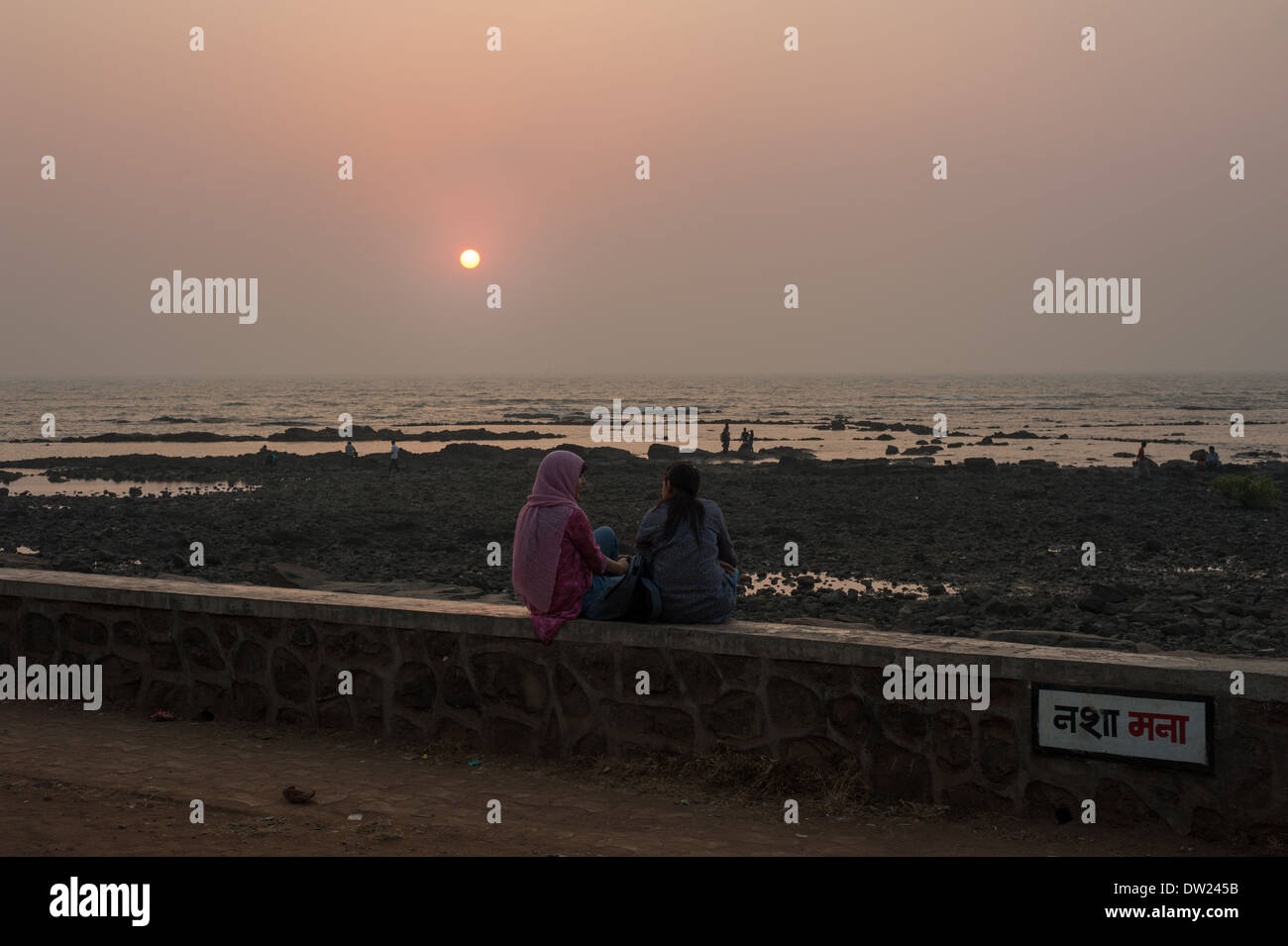 Two ladies chatting as the sunsets at the Bandstand promenade in Bandra ...