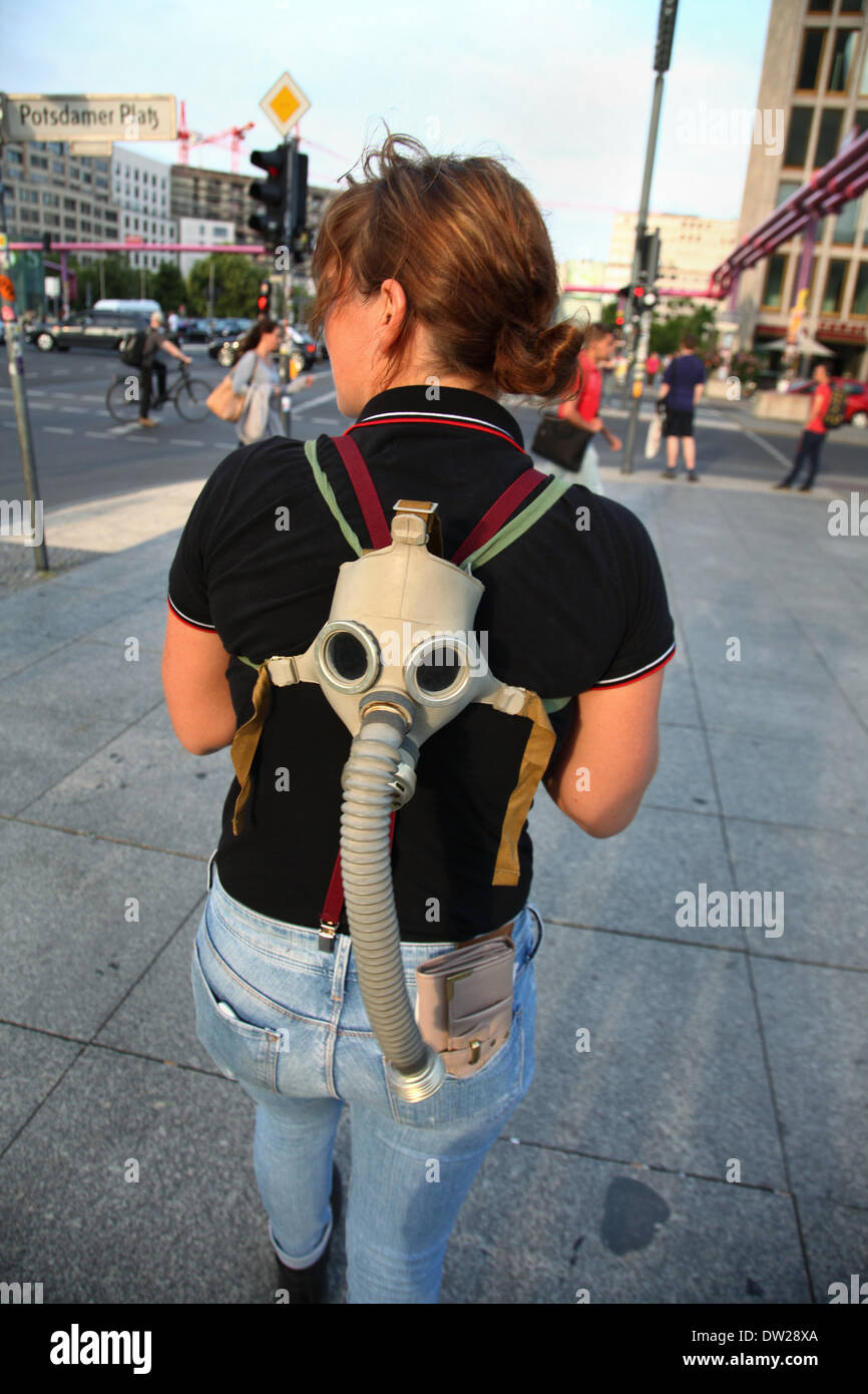 A German tourist carries a gas mask at Potsdamer Platz in Berlin ...