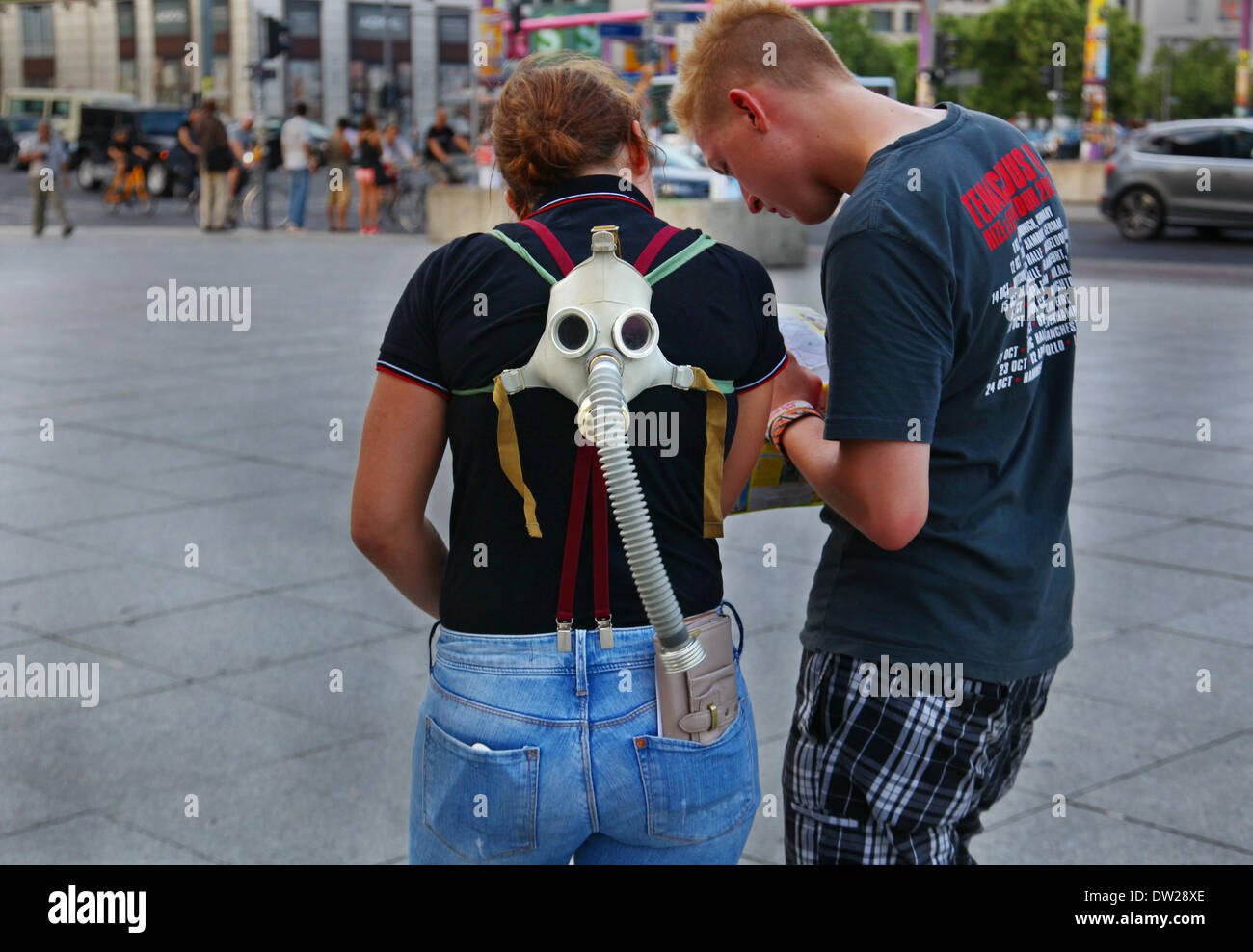 A German tourist carries a gas mask at Potsdamer Platz in Berlin ...