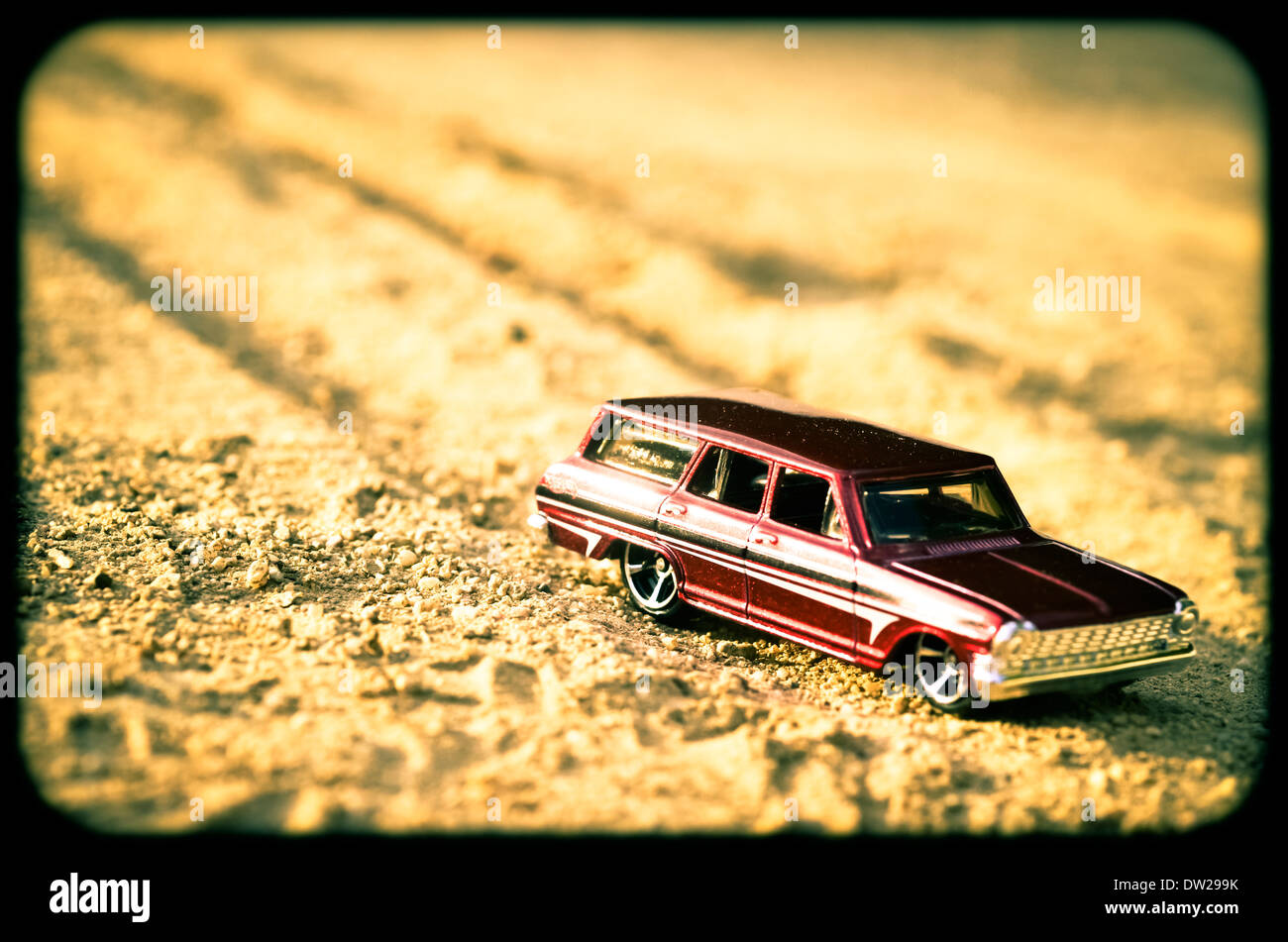 Red toy car and sand Stock Photo - Alamy