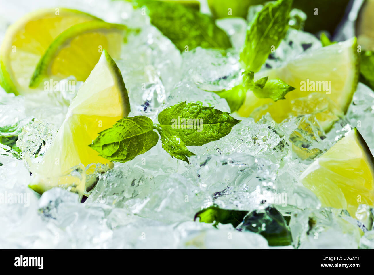 lime pieces and leaves of mint with ice Stock Photo - Alamy