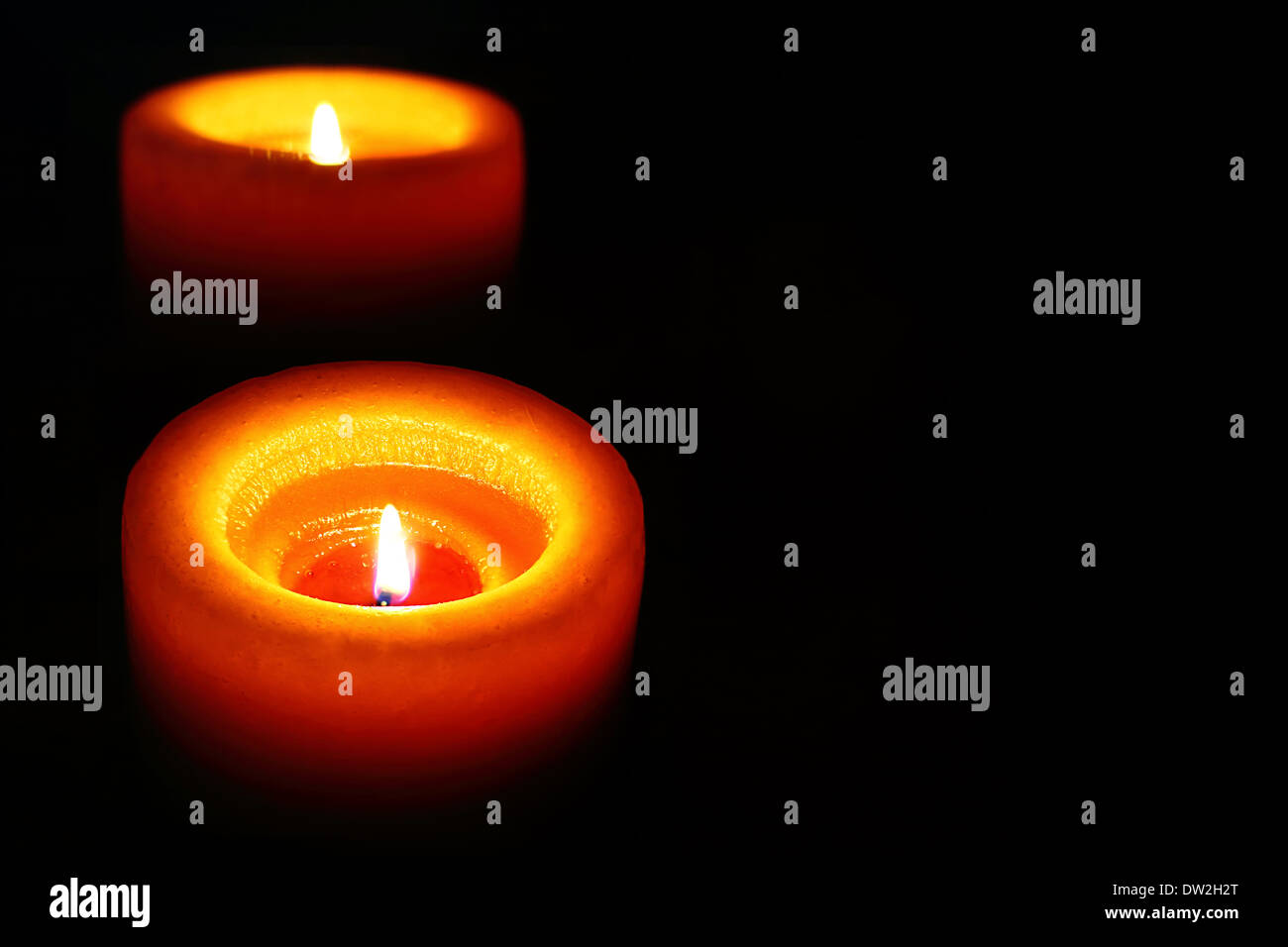 Orange Candle Reflecting In The Dark Stock Photo - Alamy