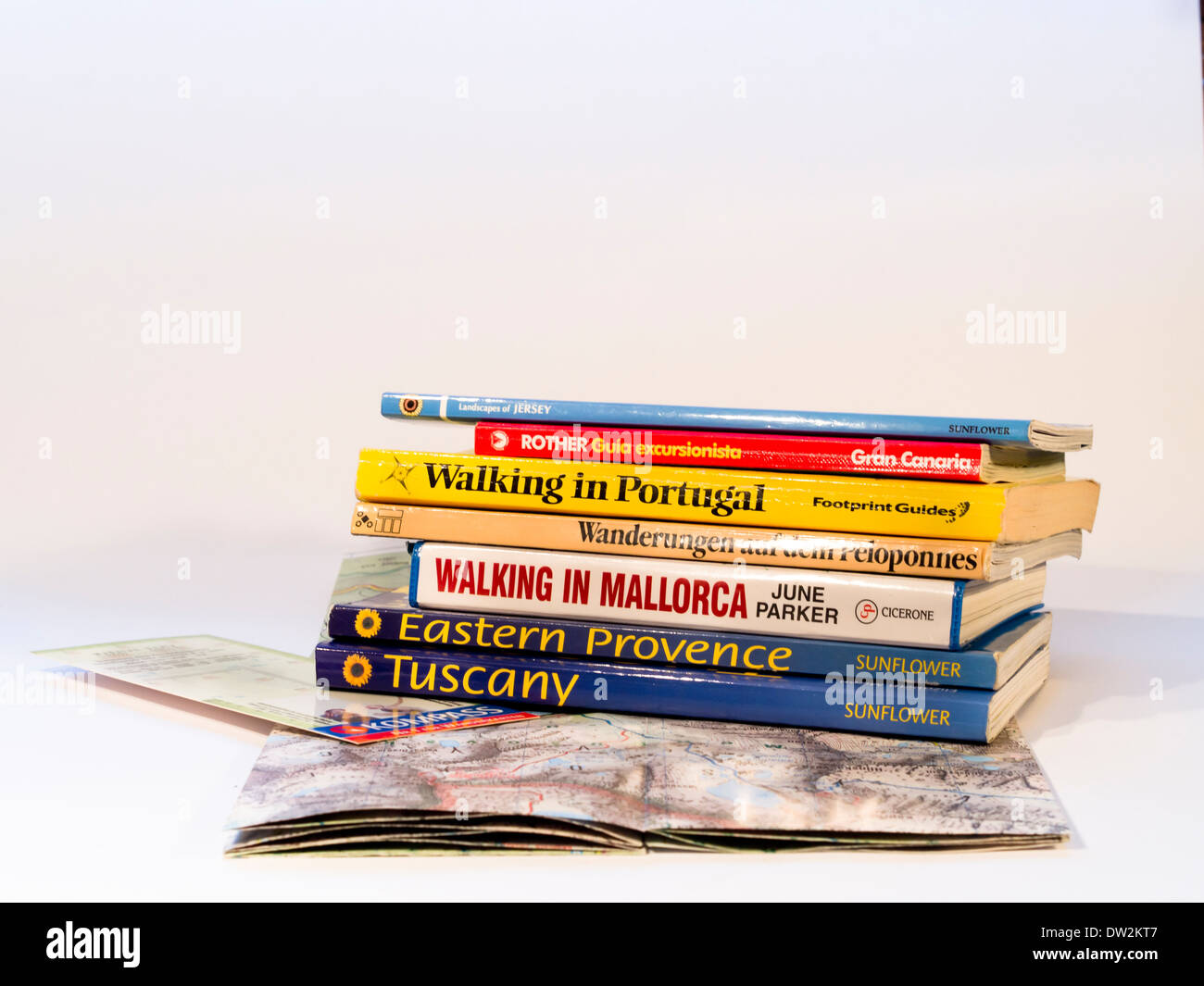 Map and stack of books for hikes in different European countries ...