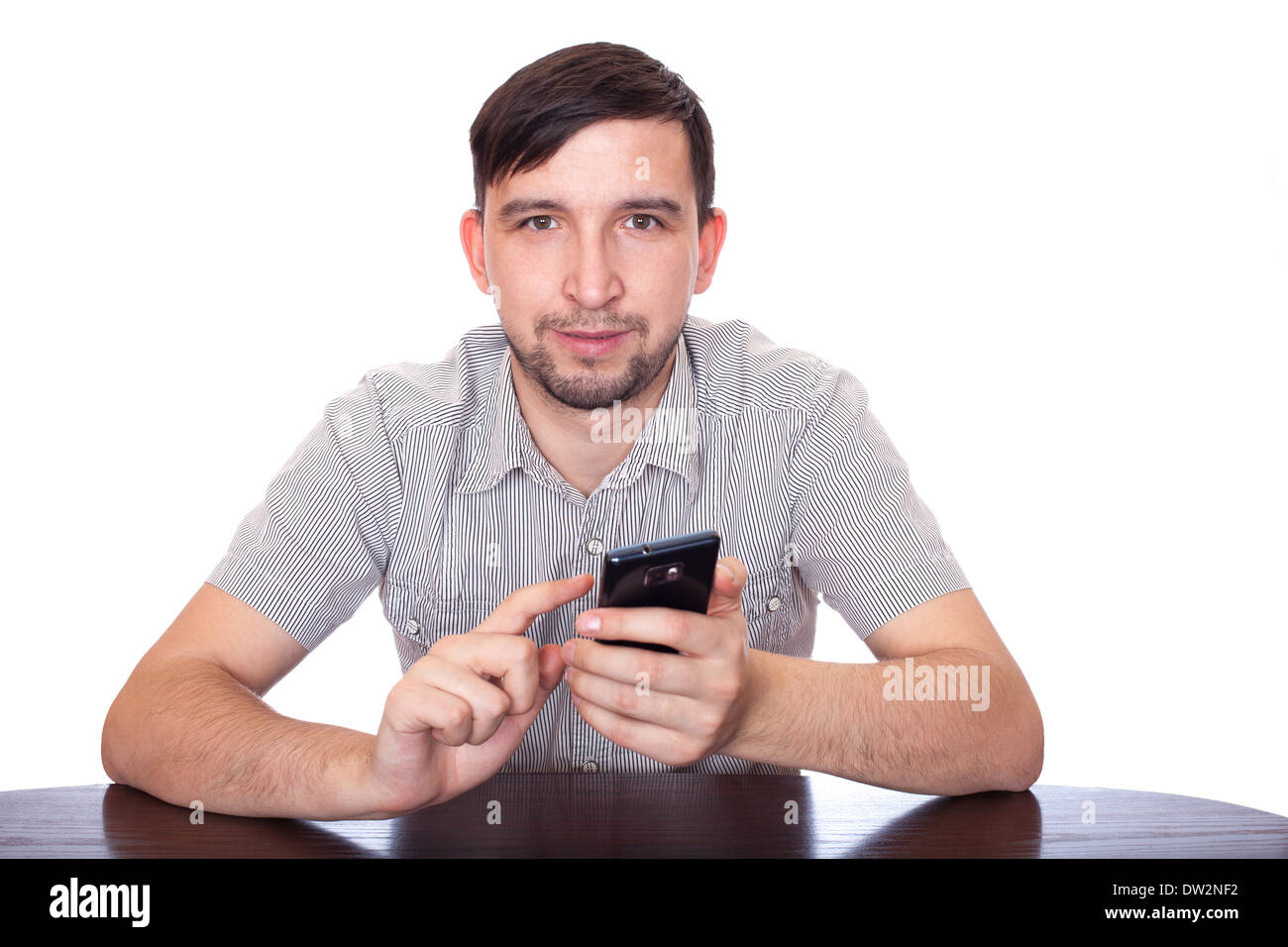 Smiling man pointing at smartphone screen on white background Stock ...