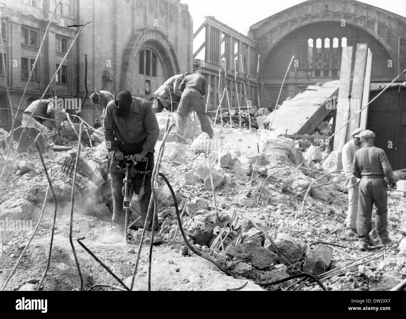 People remove debris at the main train station in Leipzig, destroyed by ...