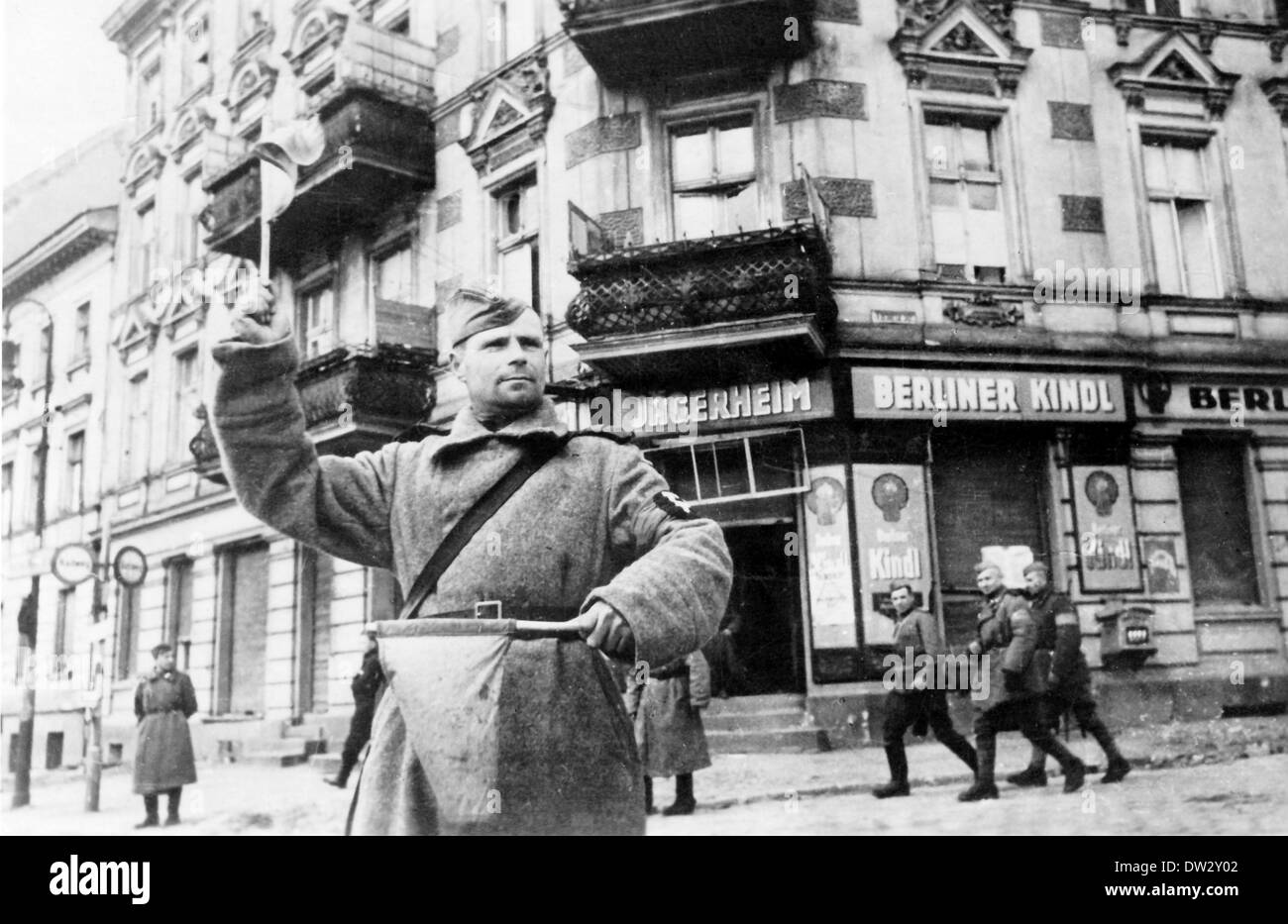 A Soviet traffic cop regulates the flow of traffic in Berlin, Germany ...