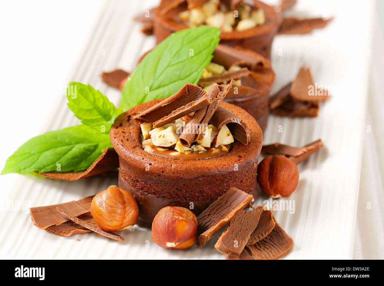 Mini chocolate cakes with hazelnut filling Stock Photo - Alamy