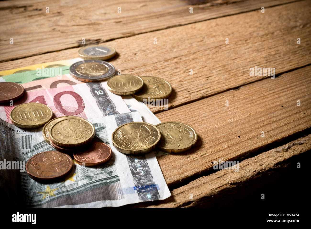 euros bank note and small change on the desk Stock Photo - Alamy