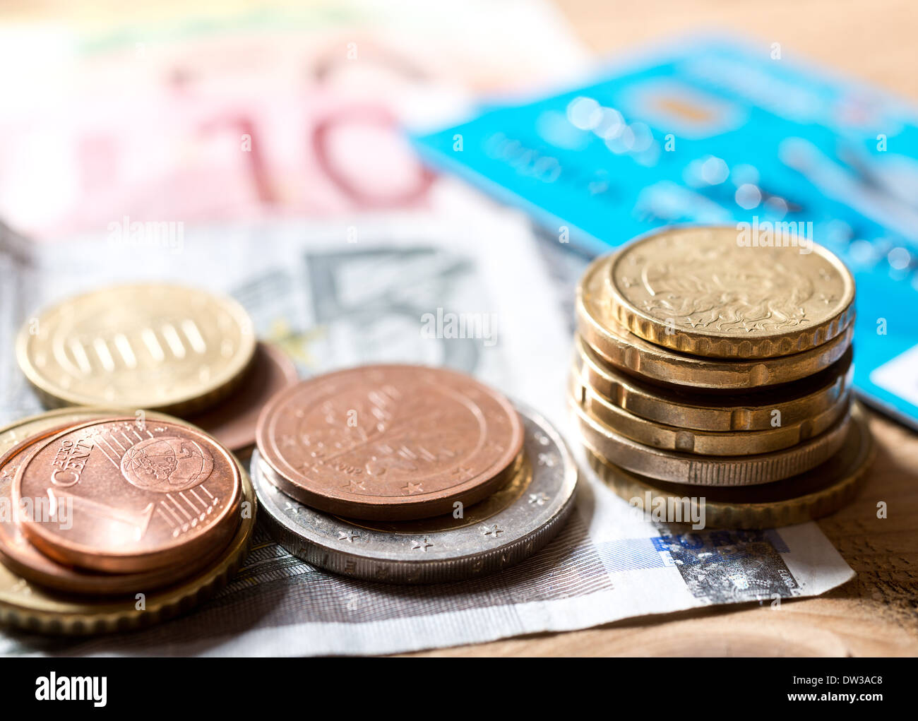euros bank note and small change on the desk Stock Photo - Alamy