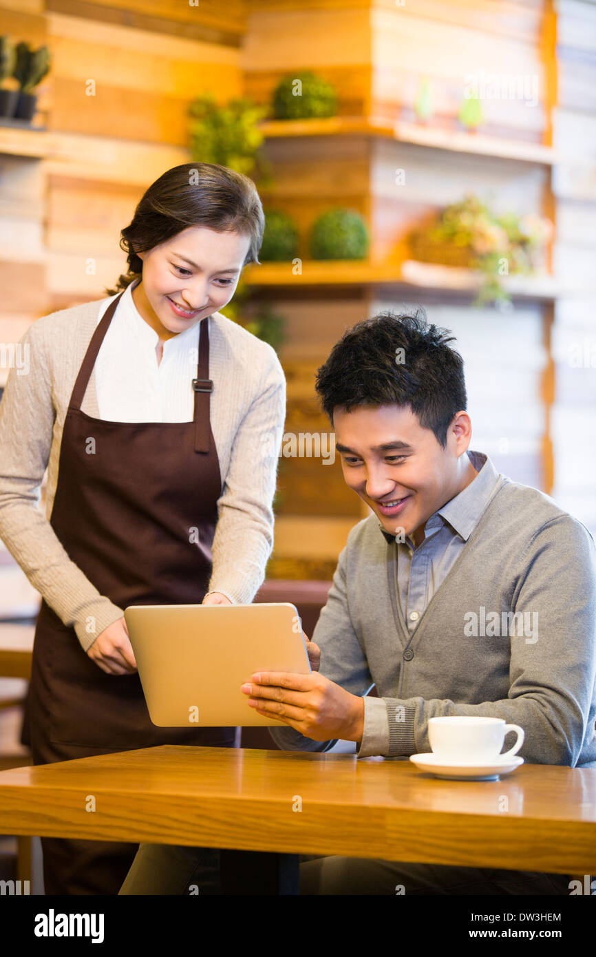 Customer using digital tablet for ordering Stock Photo - Alamy