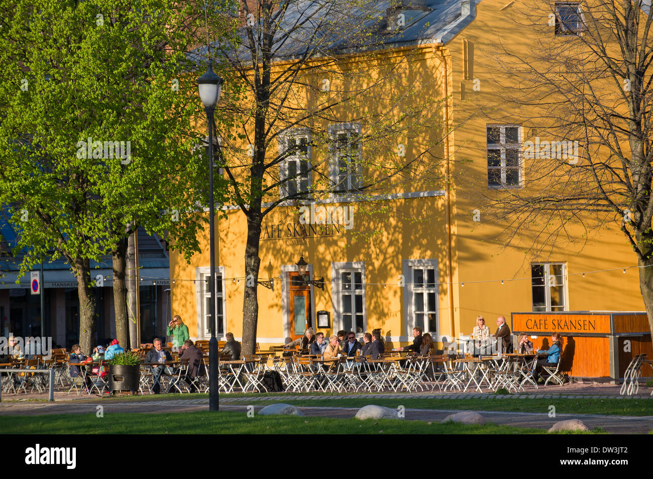 Drinkers sitting outside of the Cafe Skansen on s sunny Spring evening ...