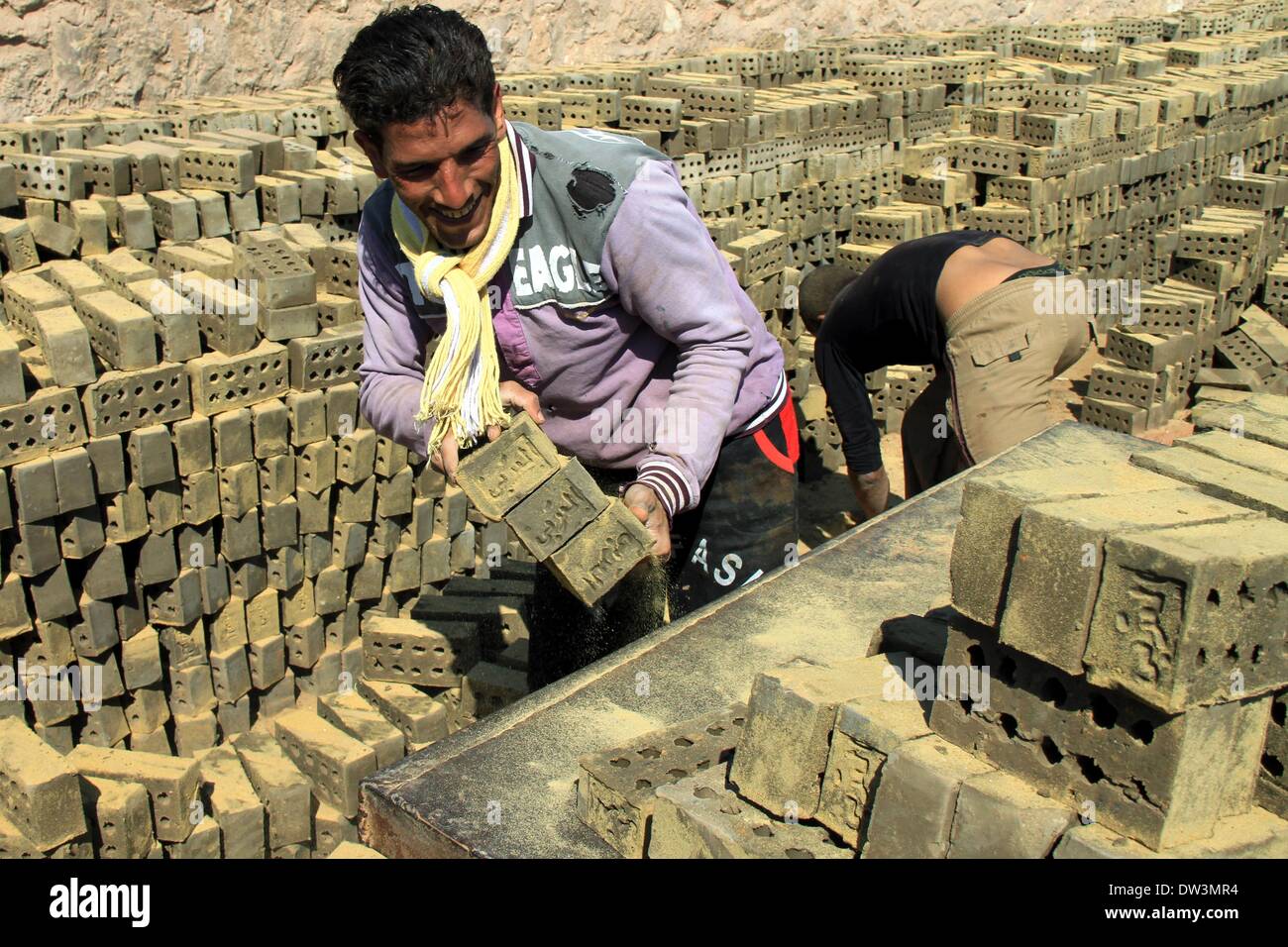 Helwan, Cairo, Egypt. 19th Feb, 2014. An Egyptian laborer works at a ...