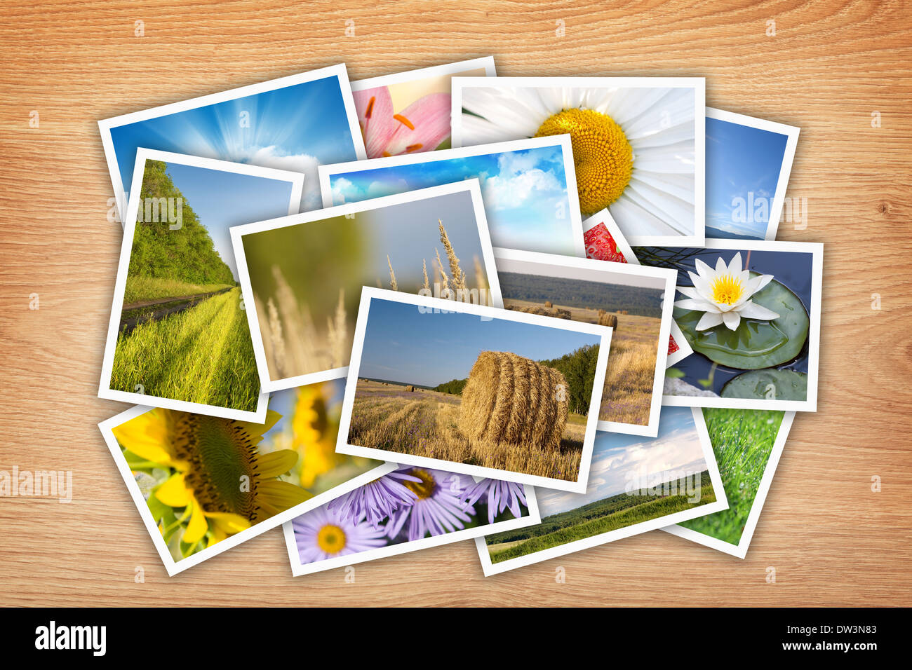 Stack of printed pictures collage on wooden table Stock Photo - Alamy