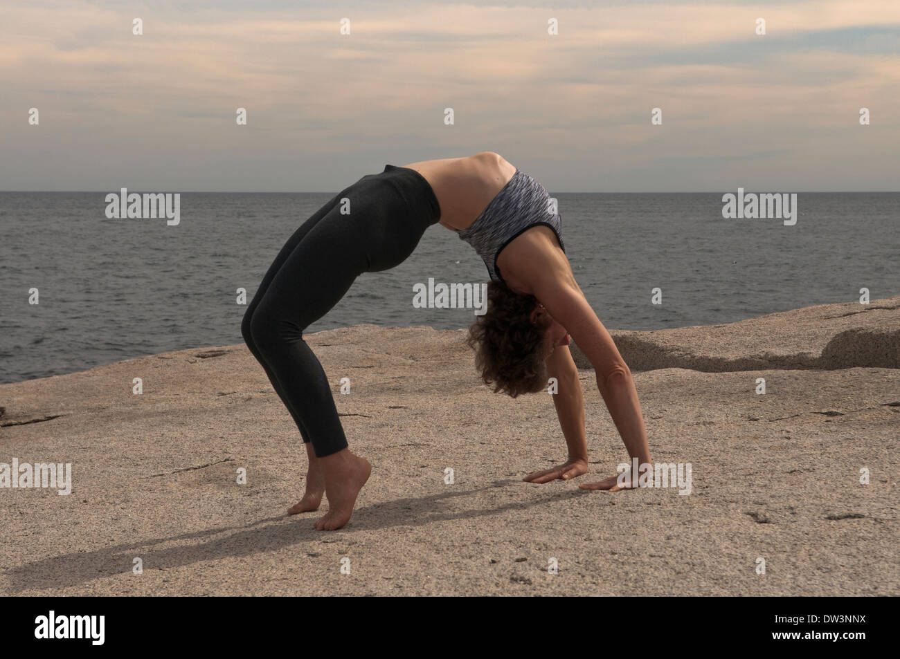 Iyengar Yoga Instructor Demonstrates Urdhva Dhanurasana Backbend Stock
