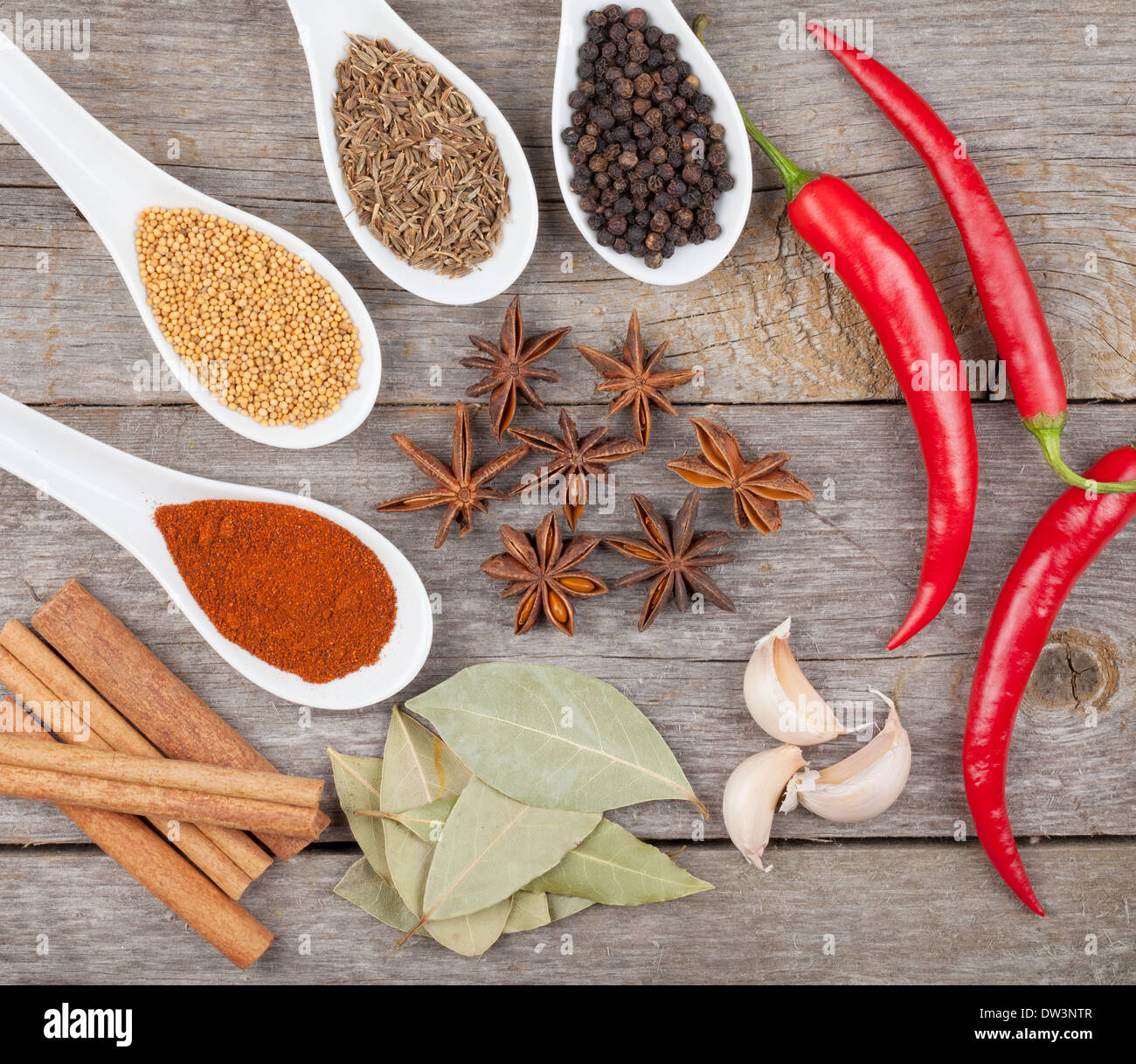 Colorful herbs and spices selection. Aromatic ingredients on wood table ...