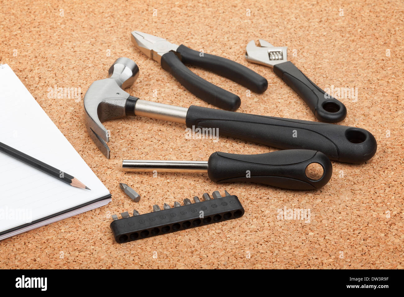 Set of tools on cork panel background Stock Photo - Alamy