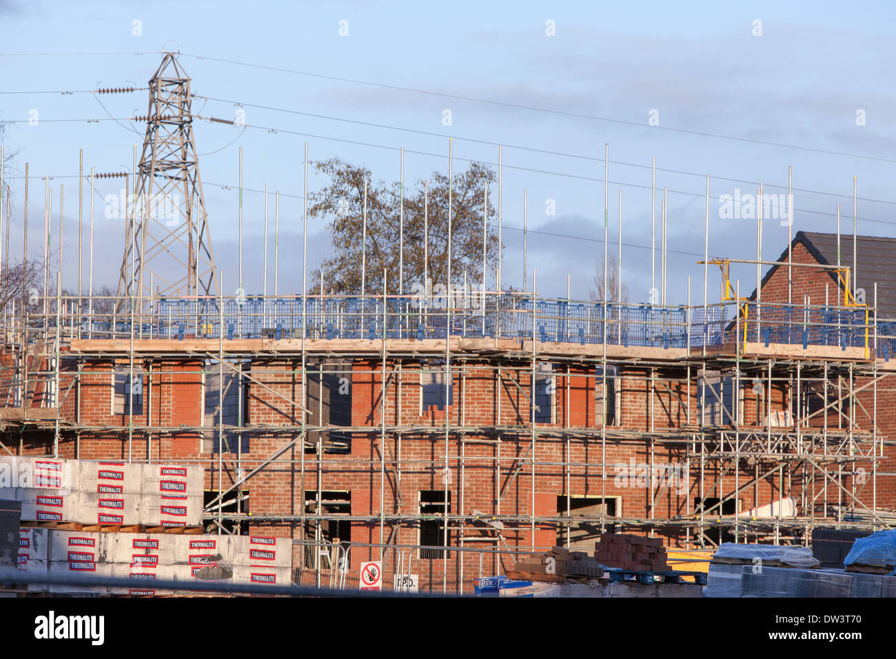Scaffolding around new housing development overlooked by pylons ...