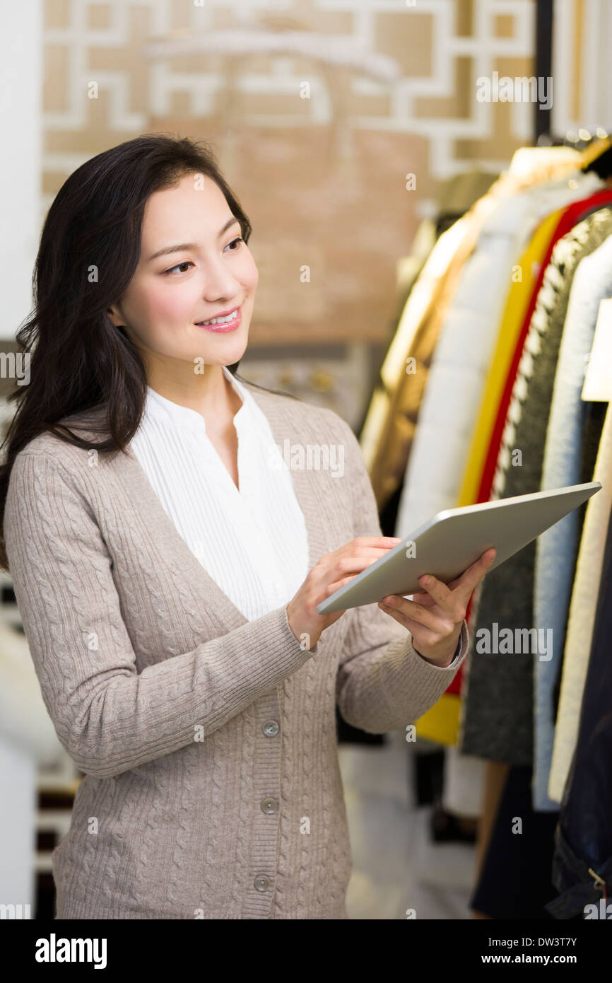 Clothing store owner with digital tablet Stock Photo - Alamy