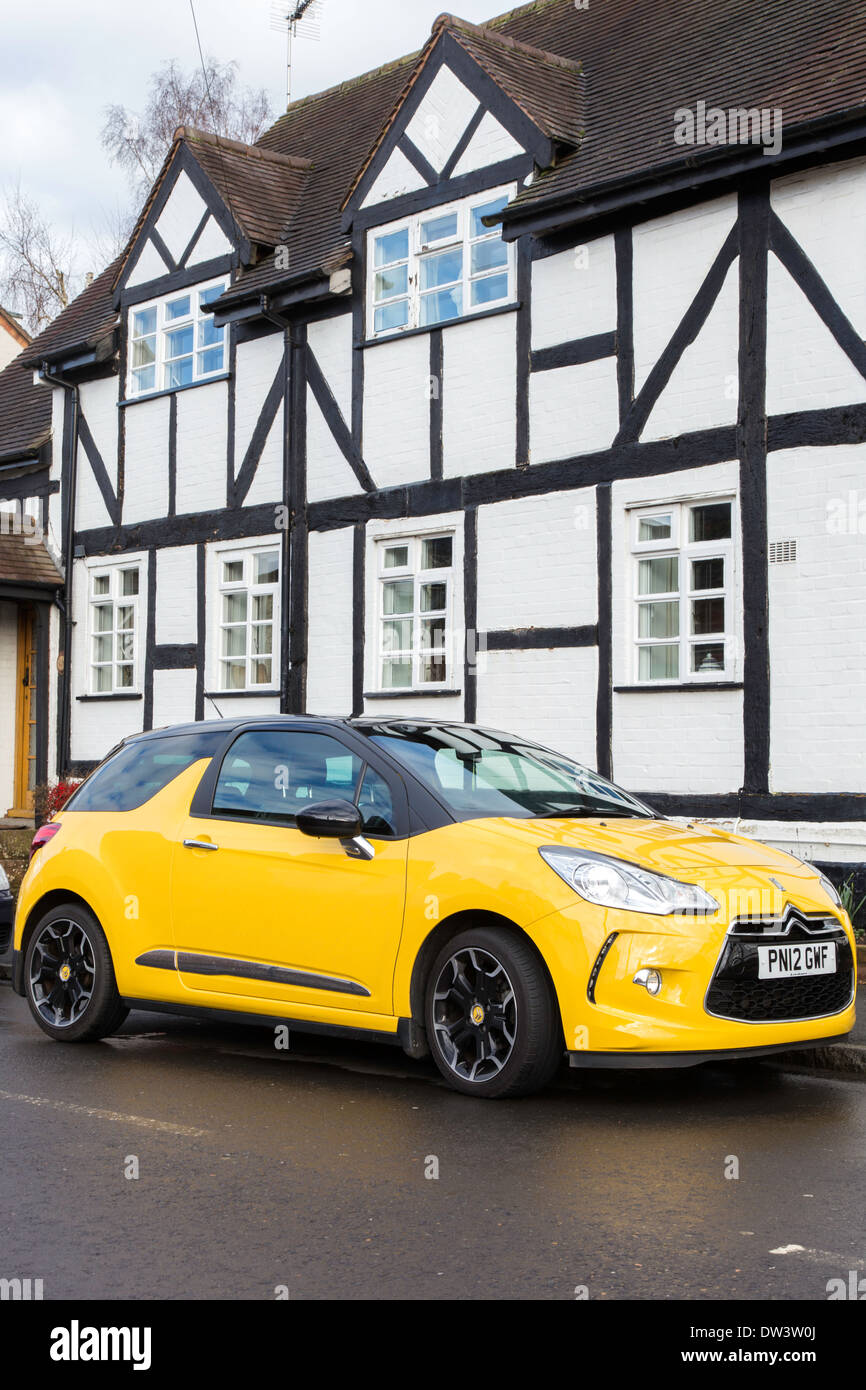 Yellow Citroen DS3 hatchback parked in front of a timber-framed cottage ...