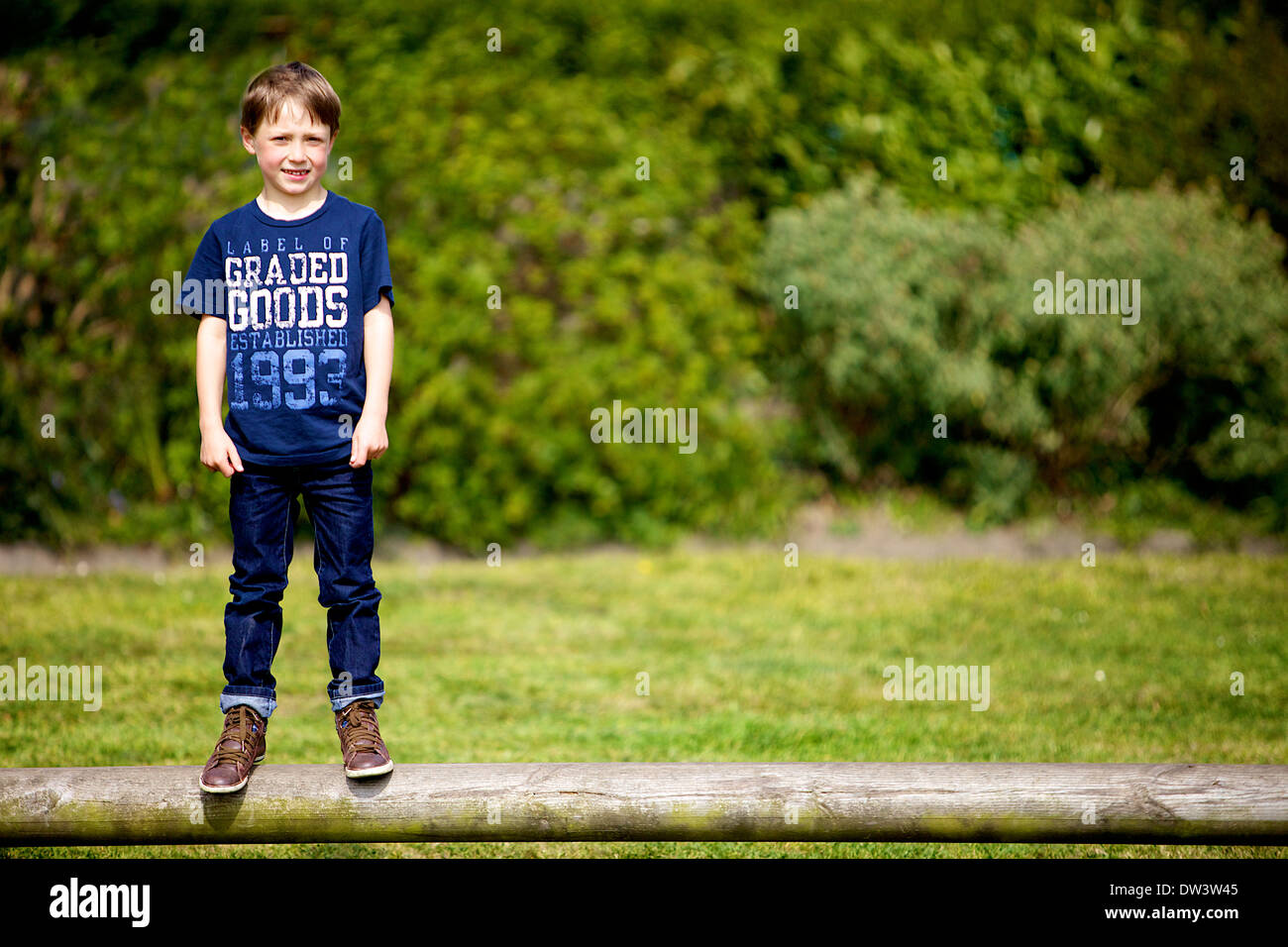child balancing on pole Stock Photo - Alamy
