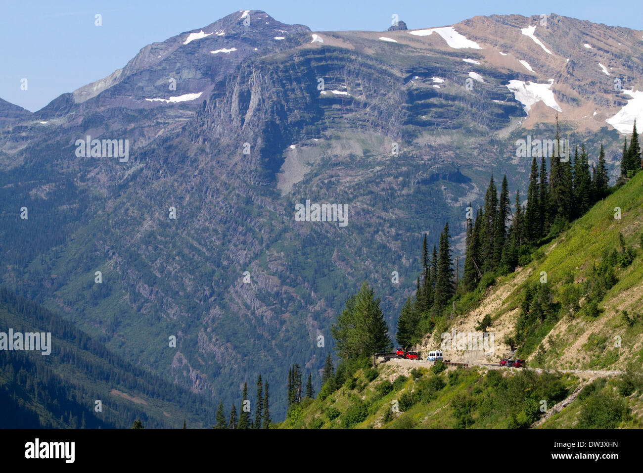 Red Jammer bus on the Going-to-the-Sun Road in Glacier National Park ...