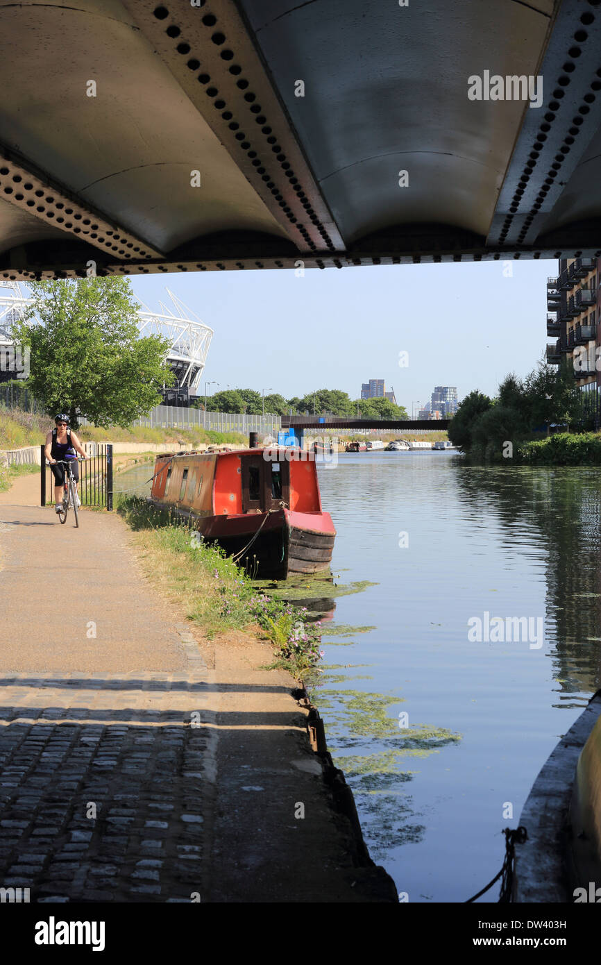 Cycling along the River Lee Navigation at trendy Hackney Wick, East ...