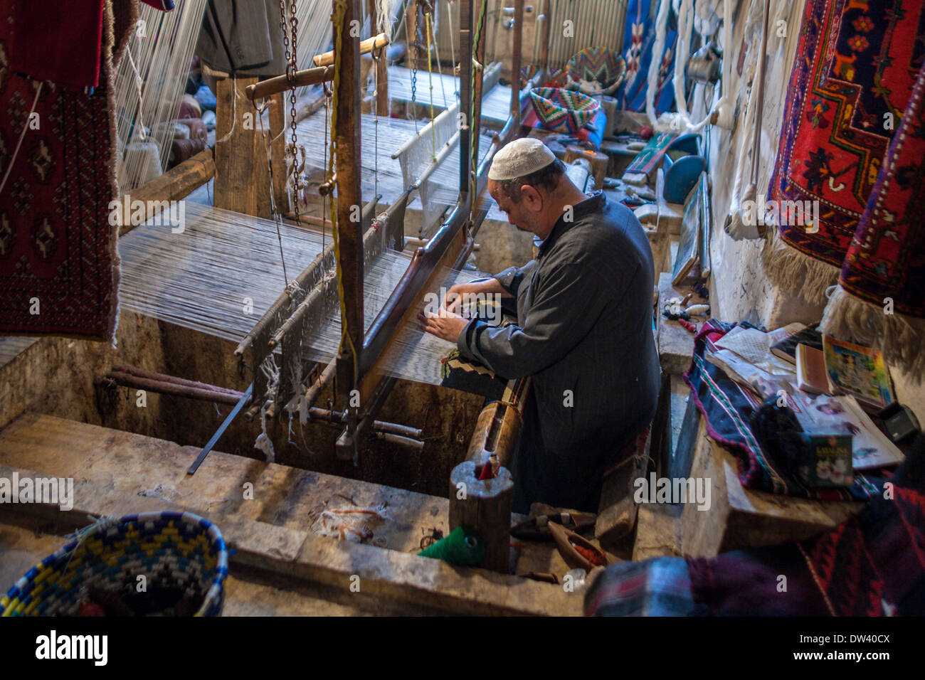 Rug weaver working in a pit loom in the central market of Aleppo, Syria ...