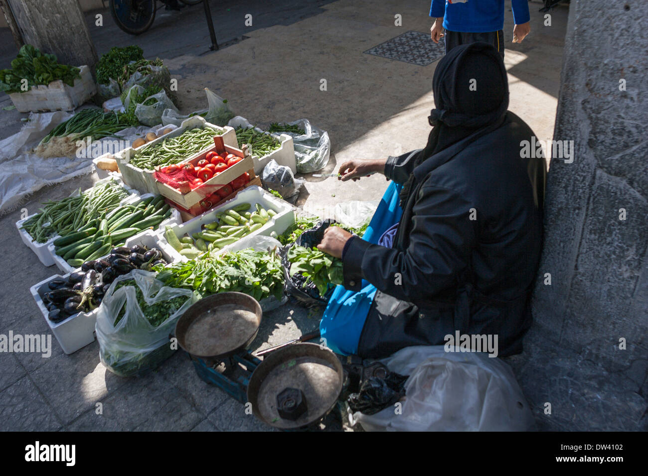 Muslim woman selling vegetables in the street in old Damascus, Syria ...
