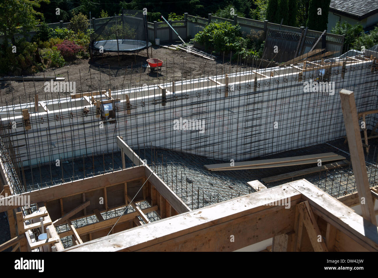 Construction for an outdoor pool being built in a backyard Stock Photo ...