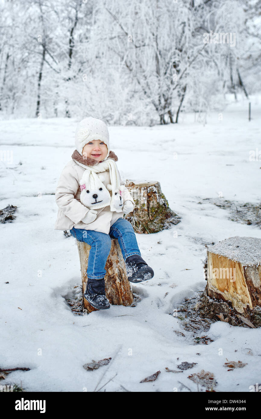 Baby girl sitting on stump hi-res stock photography and images - Alamy