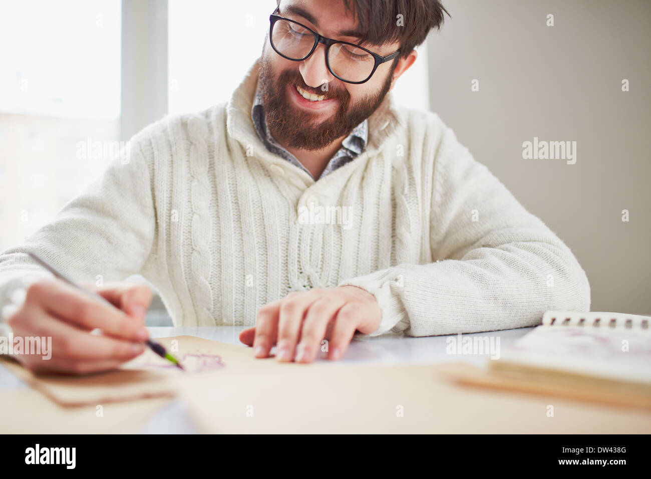 Image of happy young man drawing Stock Photo - Alamy