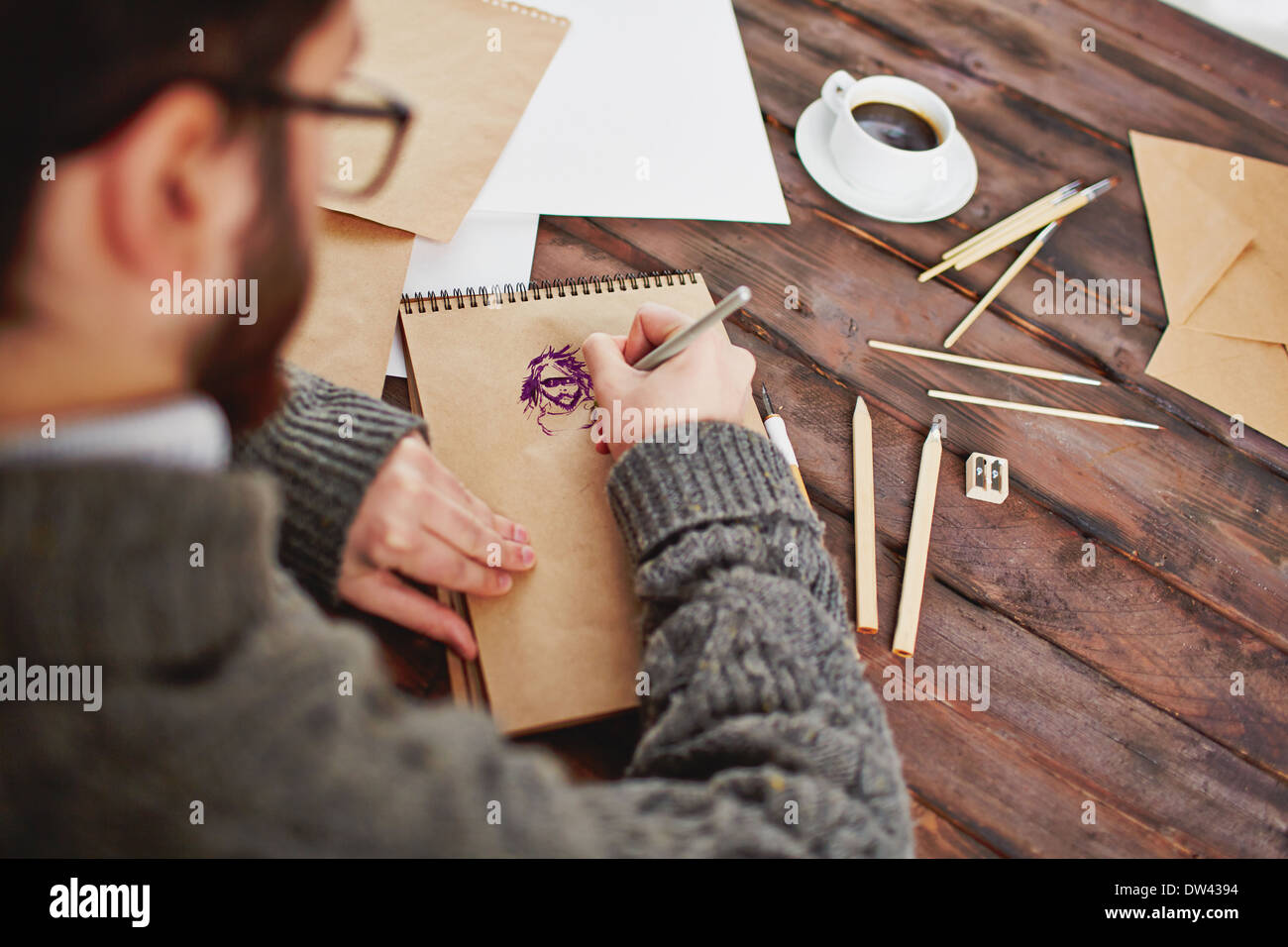 Image of male hands over notepad drawing pictures with different art ...