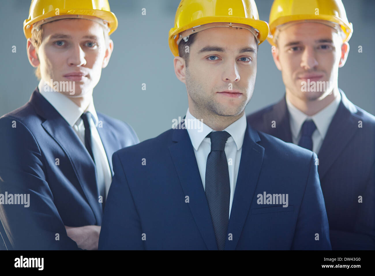 Closeup portrait of a group of contractors posing at camera with the ...